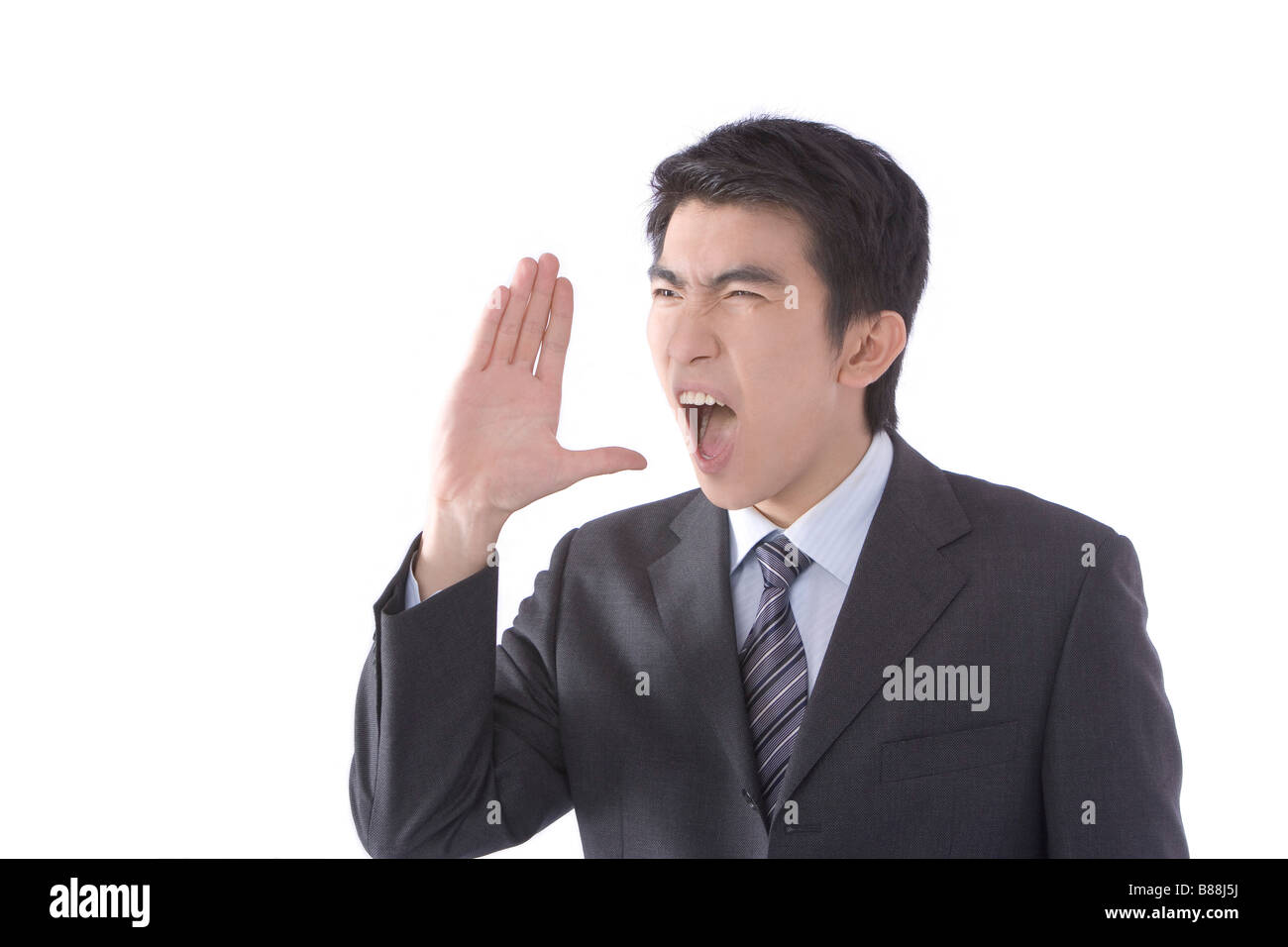 Young businessman making shouting gesture Stock Photo - Alamy