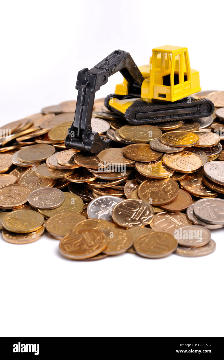 Yellow excavator on a big heap of coins Stock Photo - Alamy