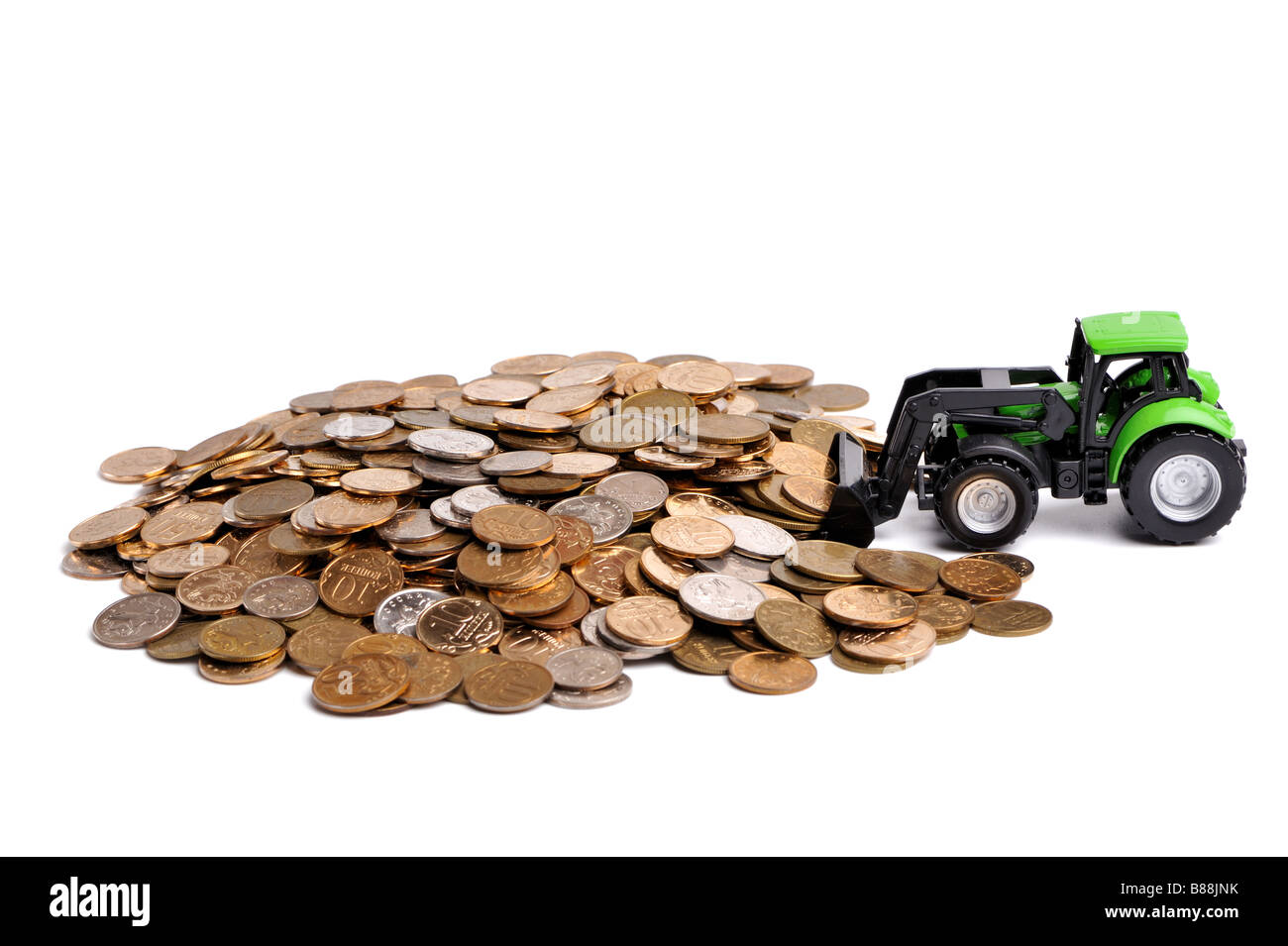 Green tractor raking up coins white background Stock Photo - Alamy