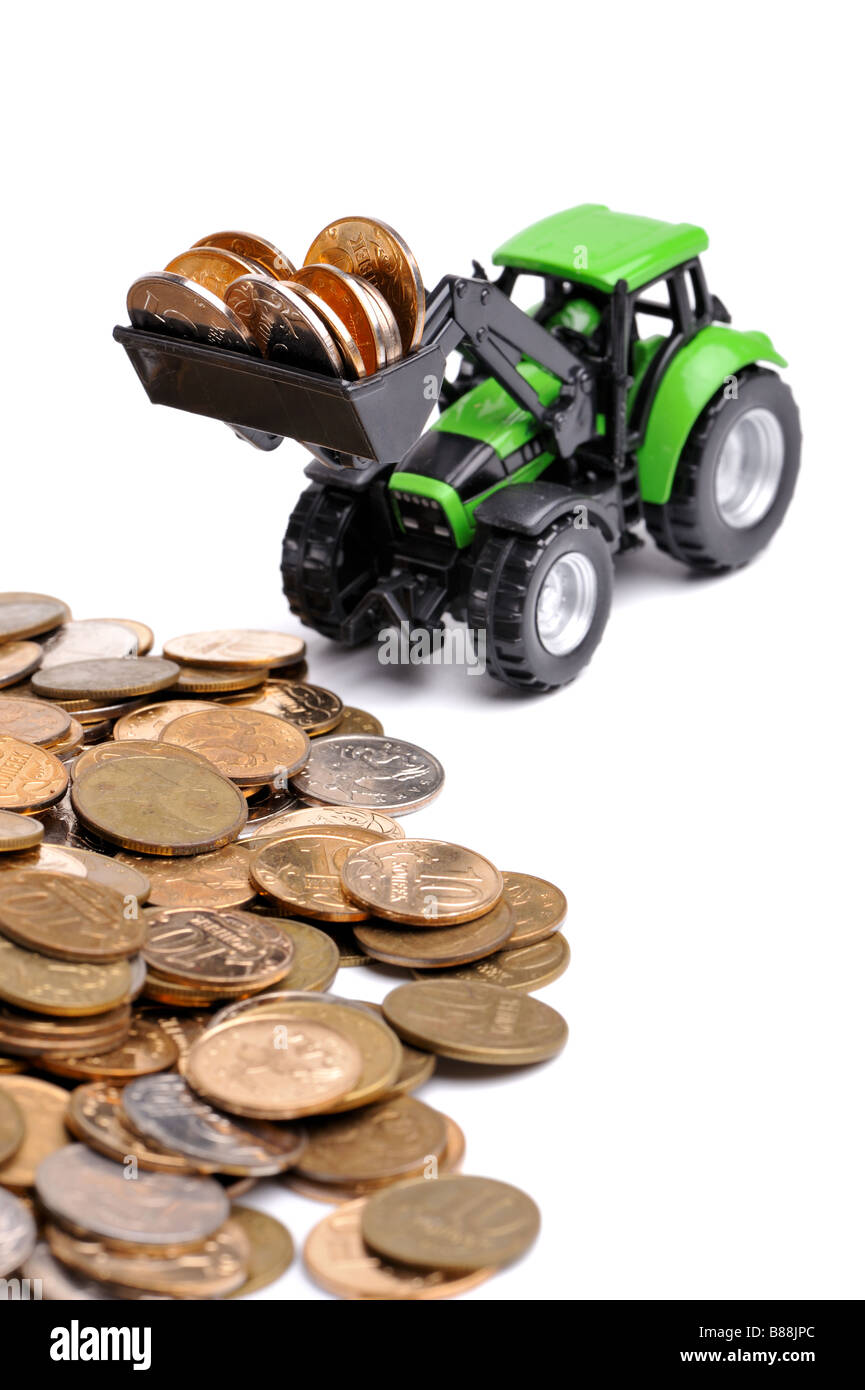 Green tractor raking up coins white background Stock Photo - Alamy