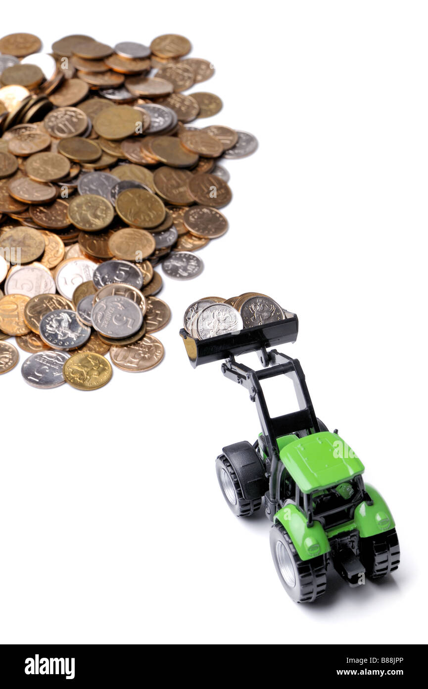 Green tractor raking up coins white background Stock Photo - Alamy