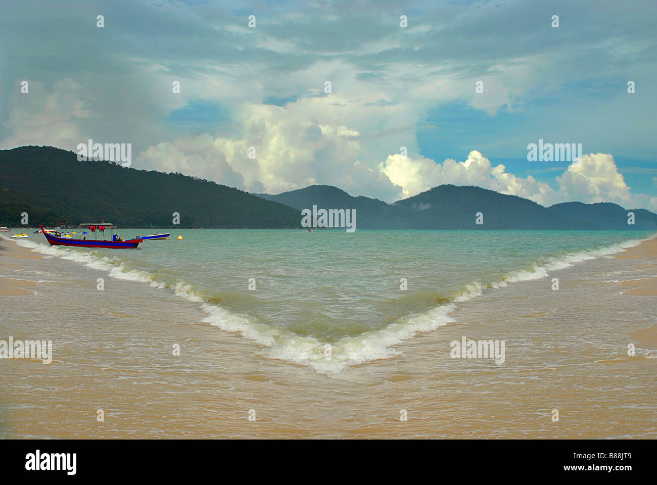Tropical beach with boat and waves rolling in in a V-shape Stock Photo ...