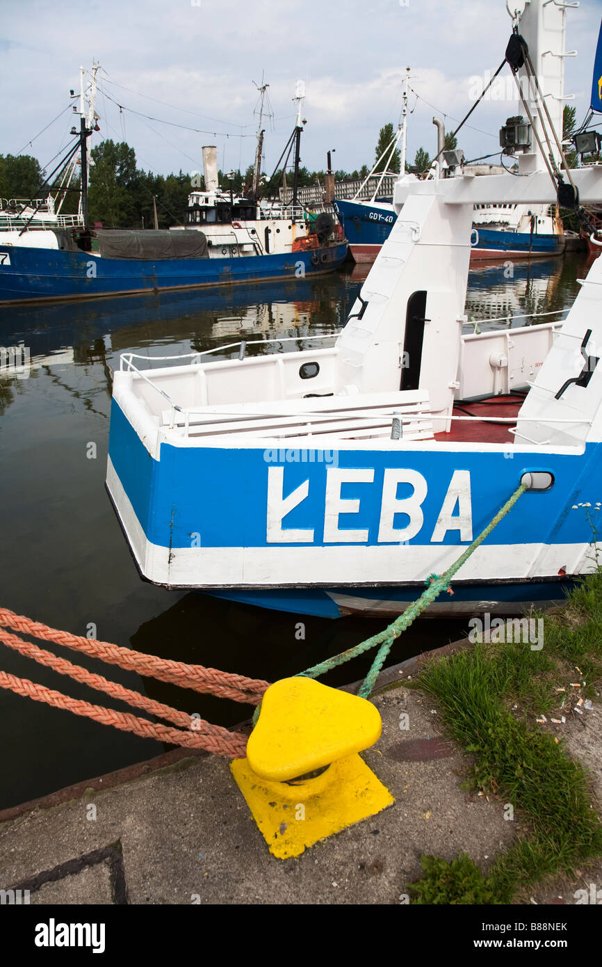 Boat tied to capstan on wharf showing registration name of town Leba ...