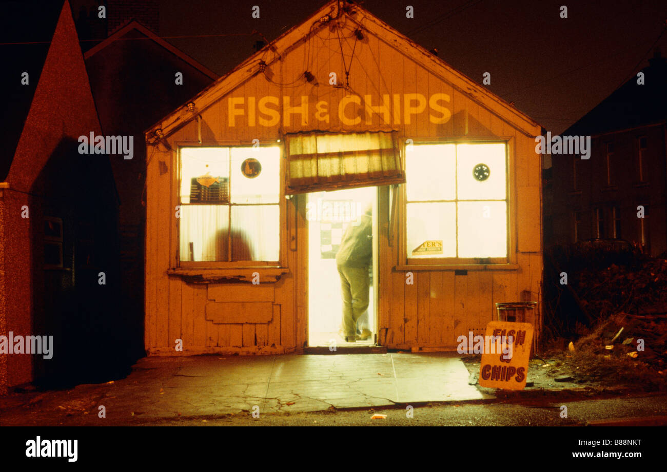 Night Small shack shop Lights Sign Fish and chips Food Man leaning on ...