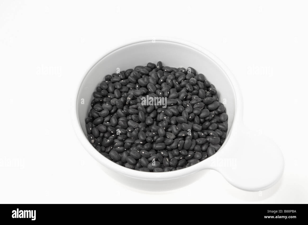 Black turtle beans on white background Stock Photo - Alamy