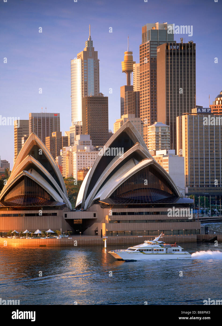 Jet boat taxi crossing Sydney Harbor under Opera House and city skyline ...