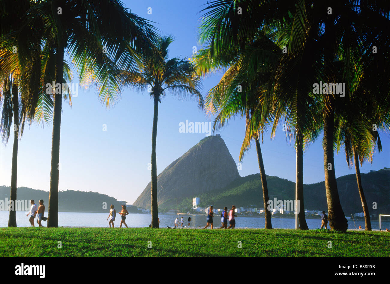 People taking morning jog and walk along Flamengo Beach near Sugar Loaf ...