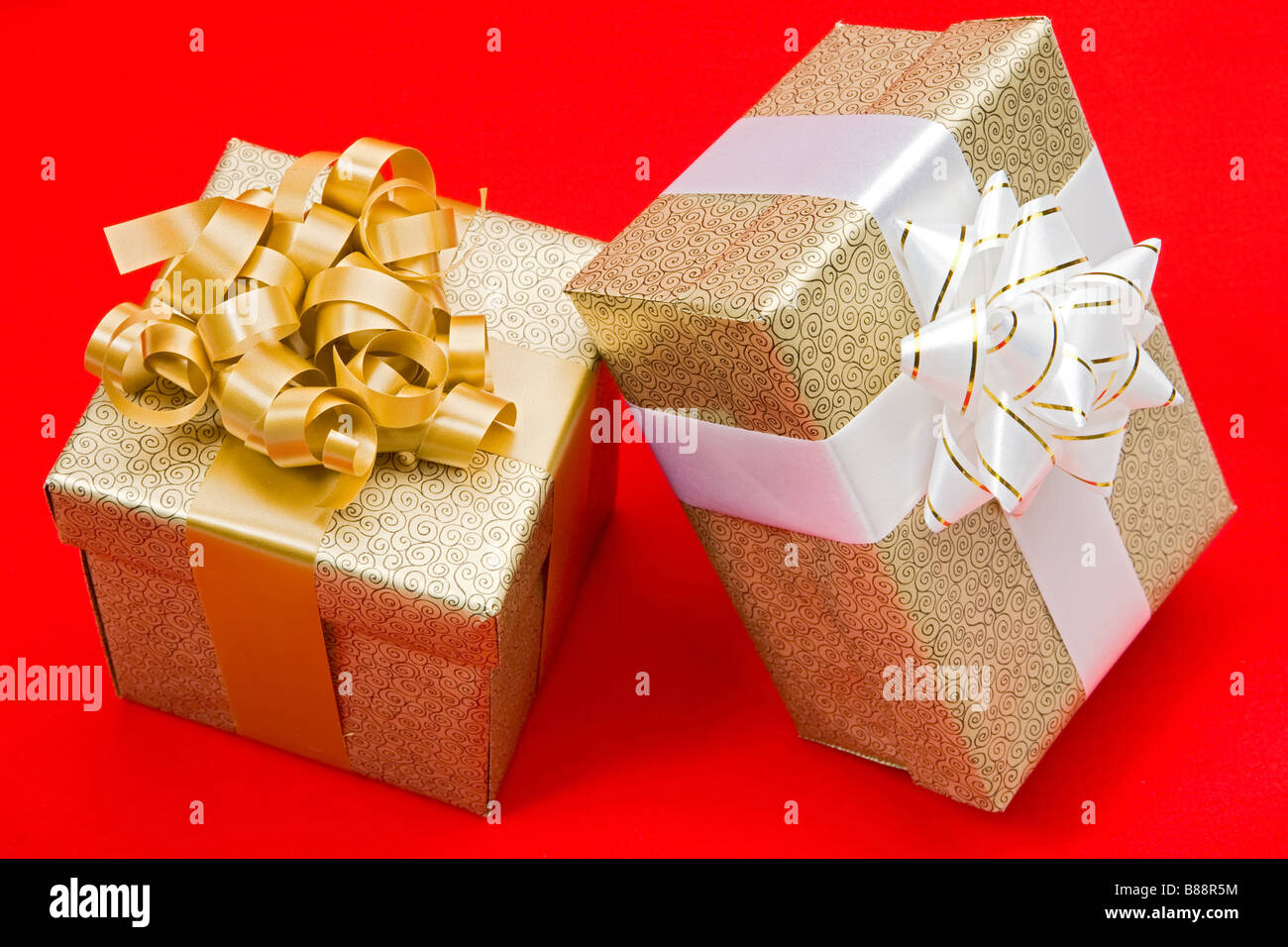 Two beautiful gifts on a over red background Stock Photo - Alamy