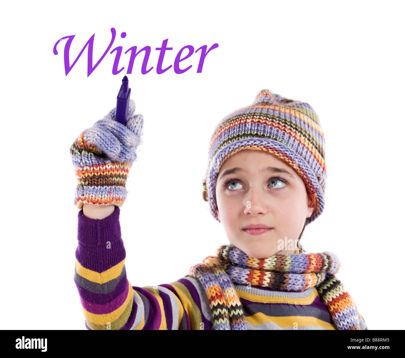 Adorable little girl with clothes for the winter writing isolated on ...