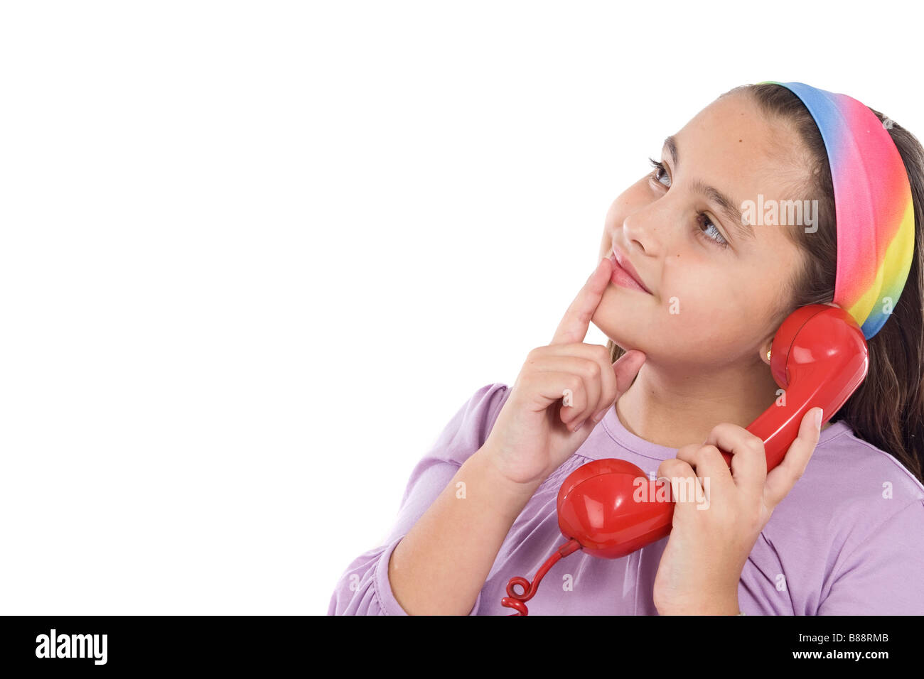 Beautiful girl with red telephone thinking on a over white background ...
