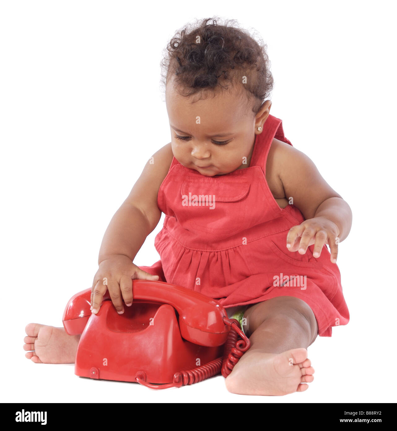 Baby with red phone a over white background Stock Photo - Alamy