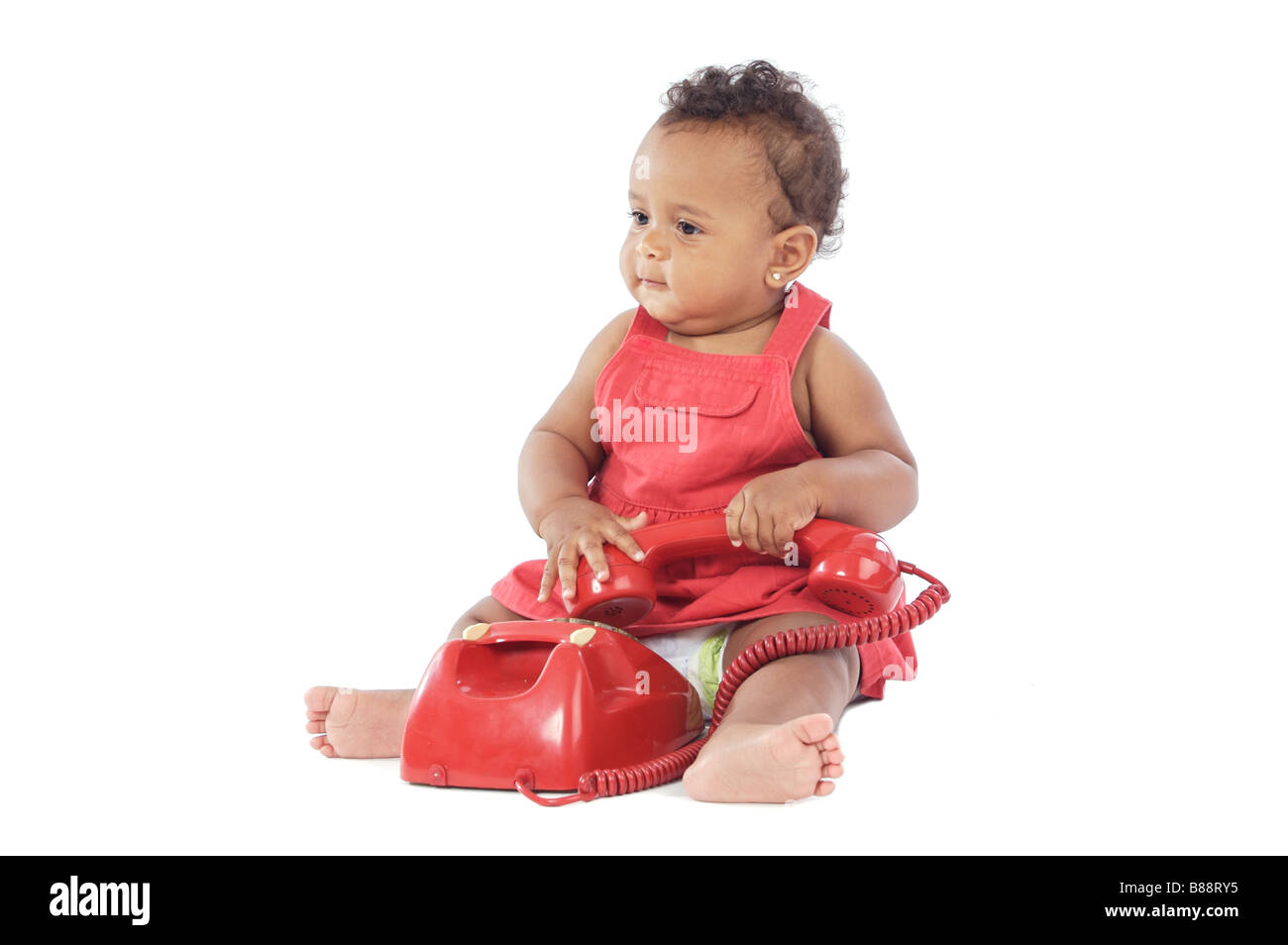 Baby with red phone a over white background Stock Photo - Alamy