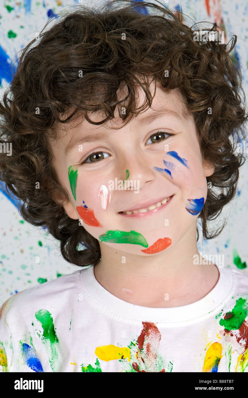 Handsome boy playing with painting with the background painted Stock ...