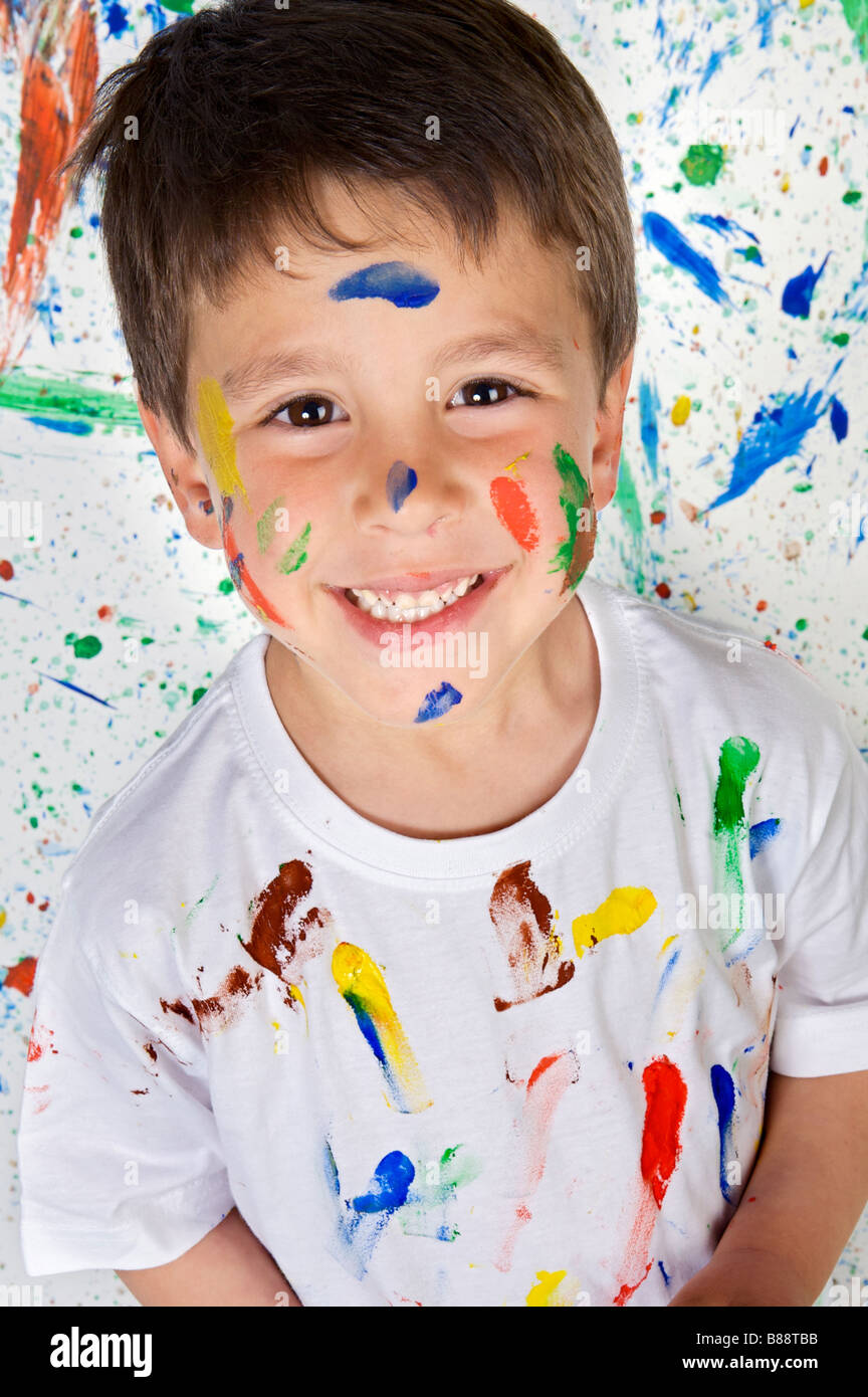 Handsome boy playing with painting with the background painted Stock ...
