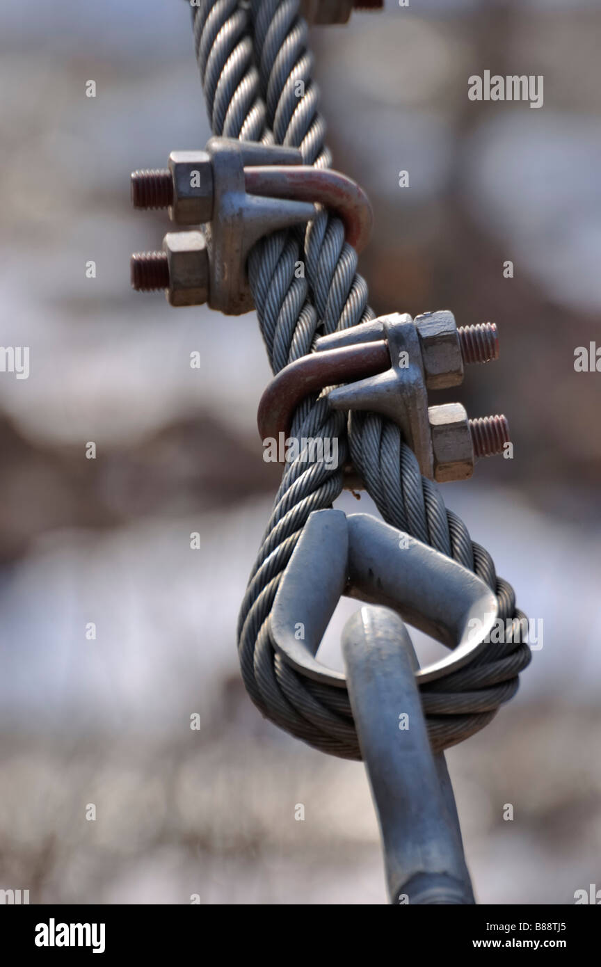 Closeup of steel eye bolts and clamps on a cable for a suspension ...
