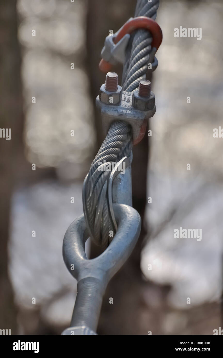 Closeup of steel eye bolts and clamps on a cable for a suspension ...