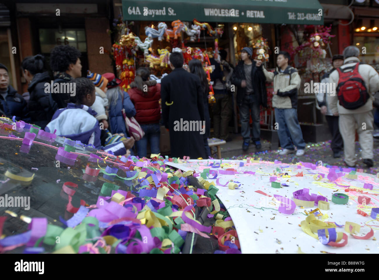 Confetti from artificial fireworks litters the streets Chinatown during ...