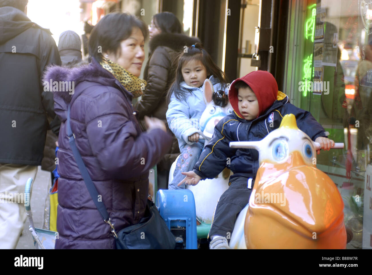 Children are treated to coin operated rides in Chinatown during the ...