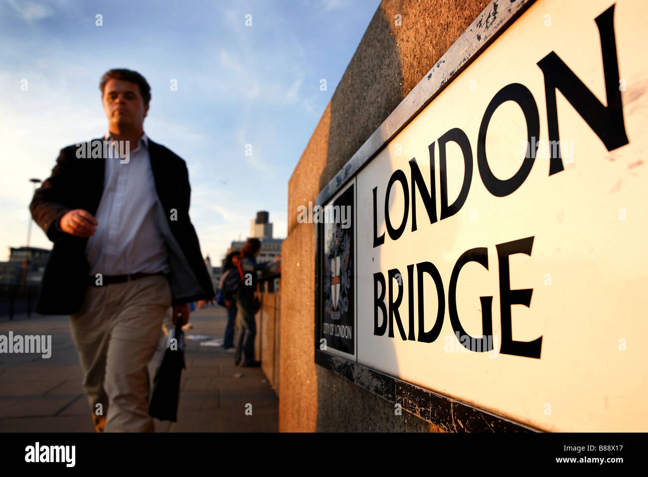A man walking across London Bridge Stock Photo - Alamy
