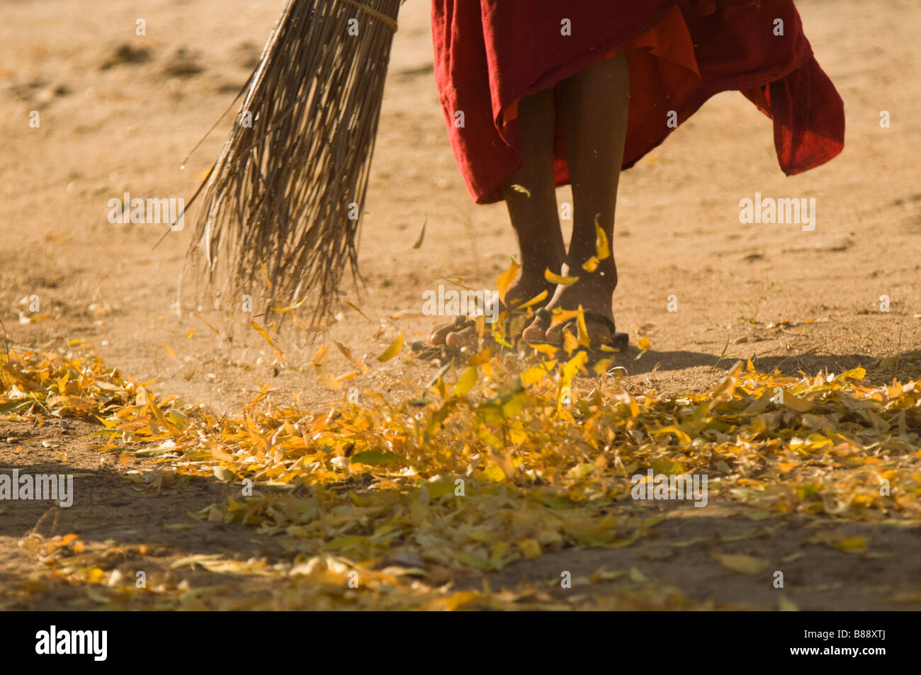 Buddhist monk sweeping leaves hi-res stock photography and images - Alamy