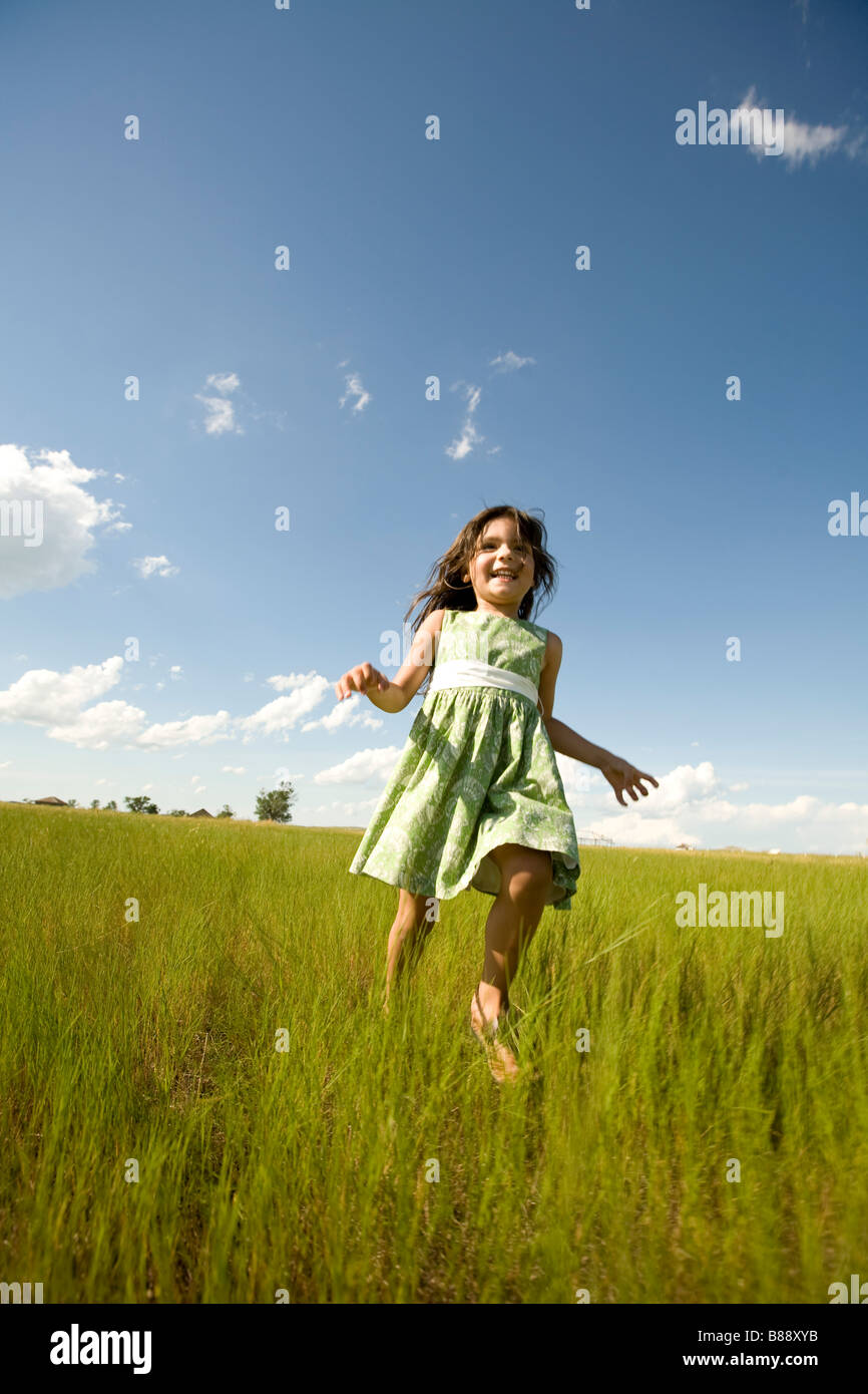 Girl running through tall grass hi-res stock photography and images - Alamy