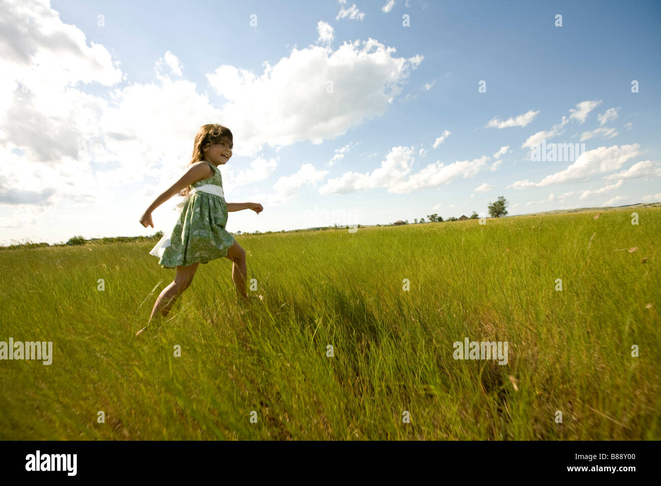 Girl running through a grassy field in North Dakota Stock Photo - Alamy