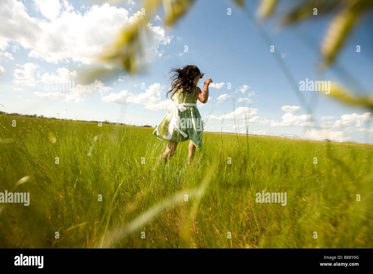Girl running through tall grass hi-res stock photography and images - Alamy