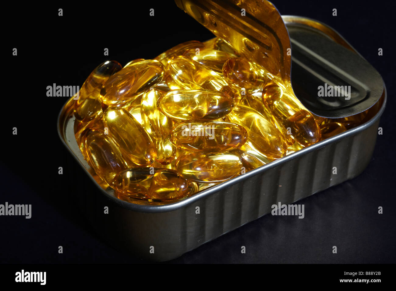 Fish Oil Capsules in an open Sardine Can Stock Photo - Alamy