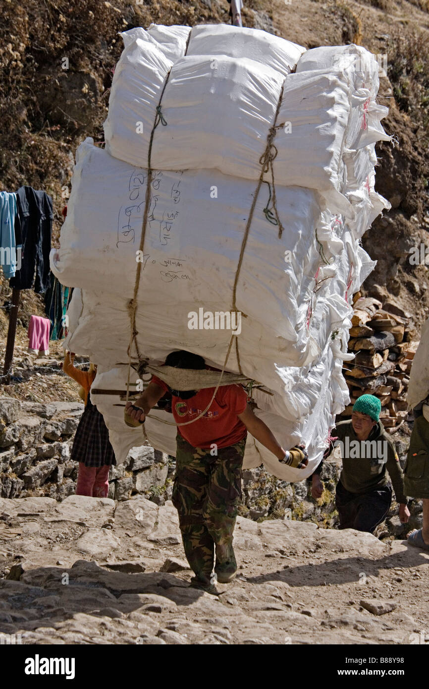 Nepali porter carrying extreme bags of empty plastic bottles in Namche ...