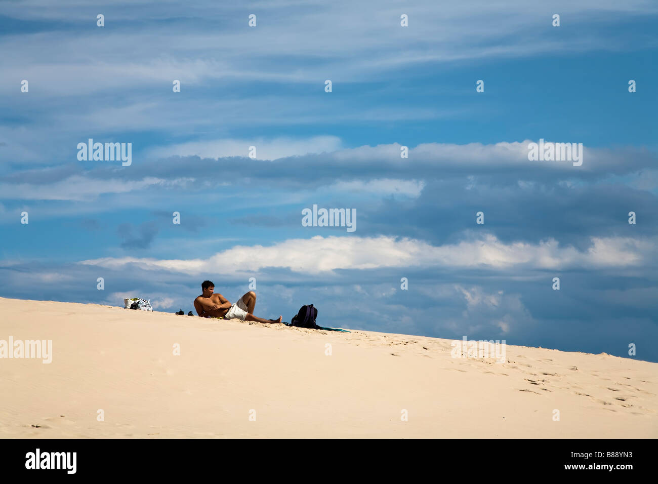 Man sunbathing in Lacka Gora dunes Slowinski national park Leba Poland ...