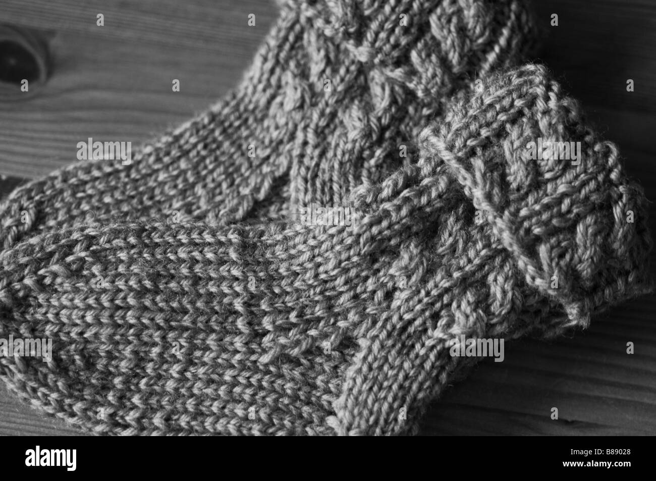 a pair of handmade knitted baby socks (Black and white photo Stock ...