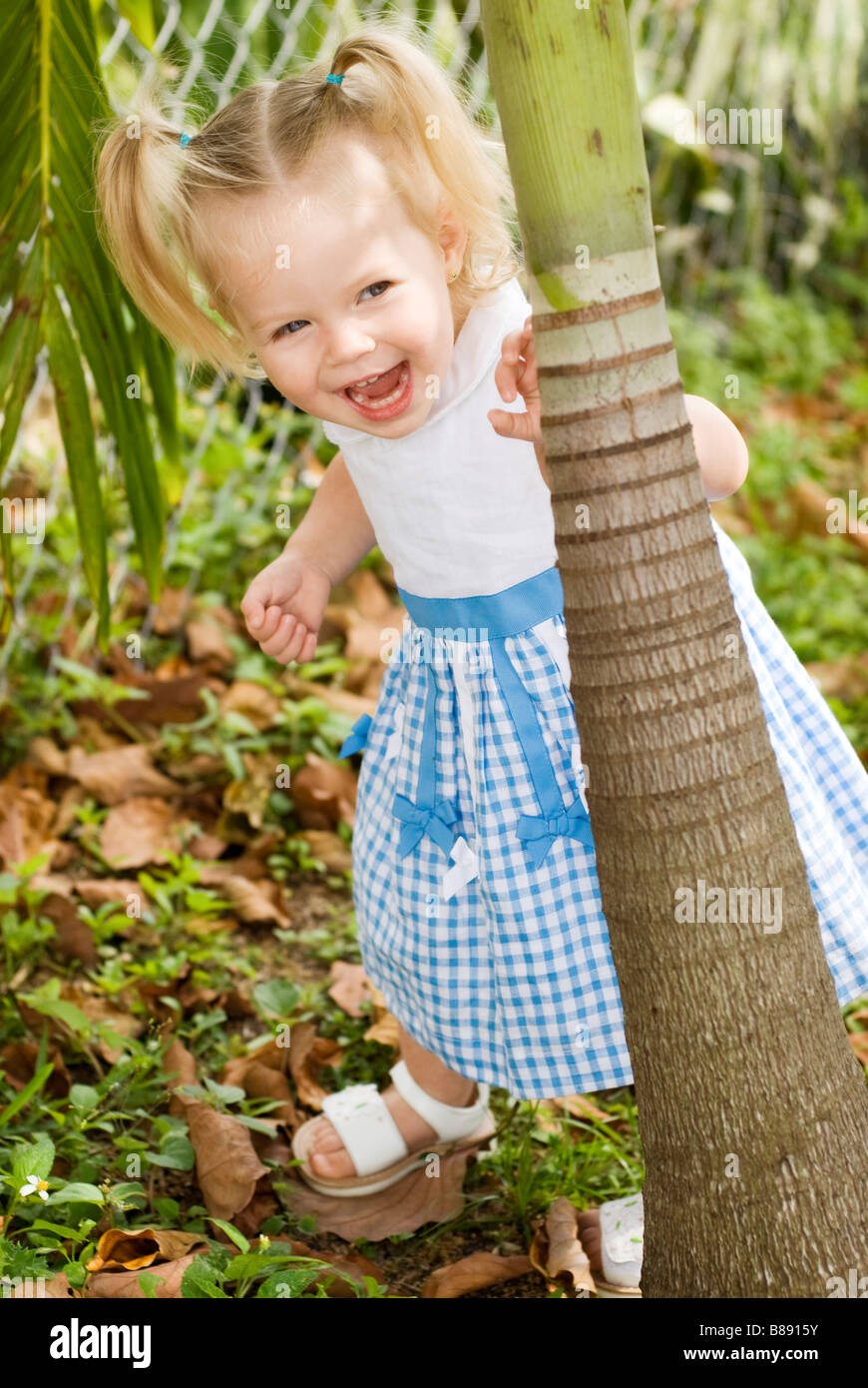 little girl playing hide & seek Stock Photo - Alamy
