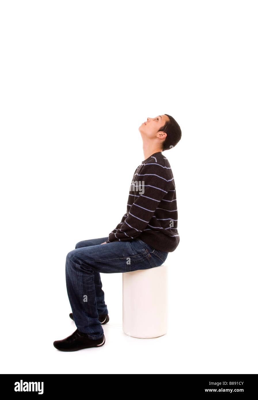 young men seated in a bench looking up to the copy space Stock Photo ...