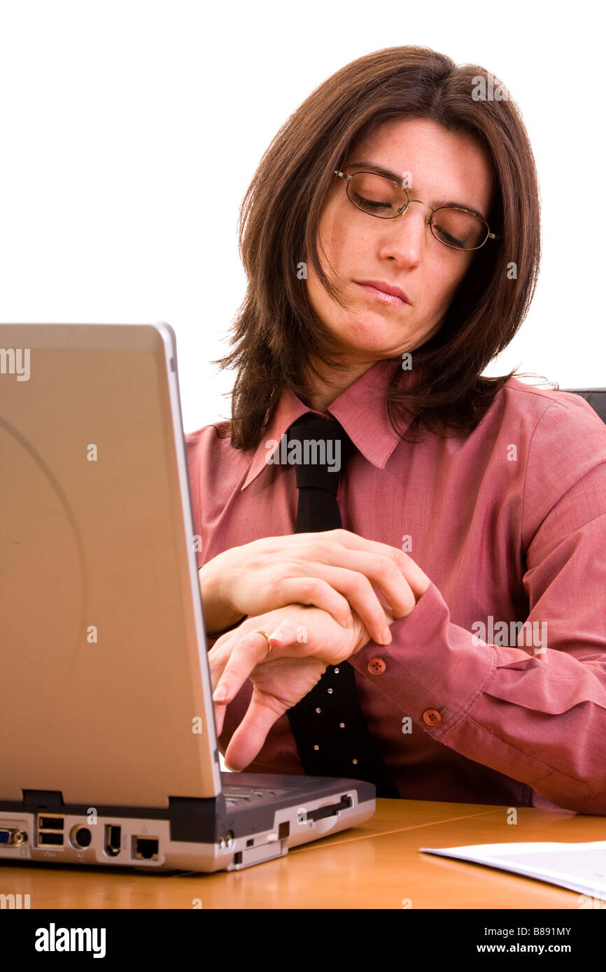businesswoman working late at the office looking at the time Stock ...