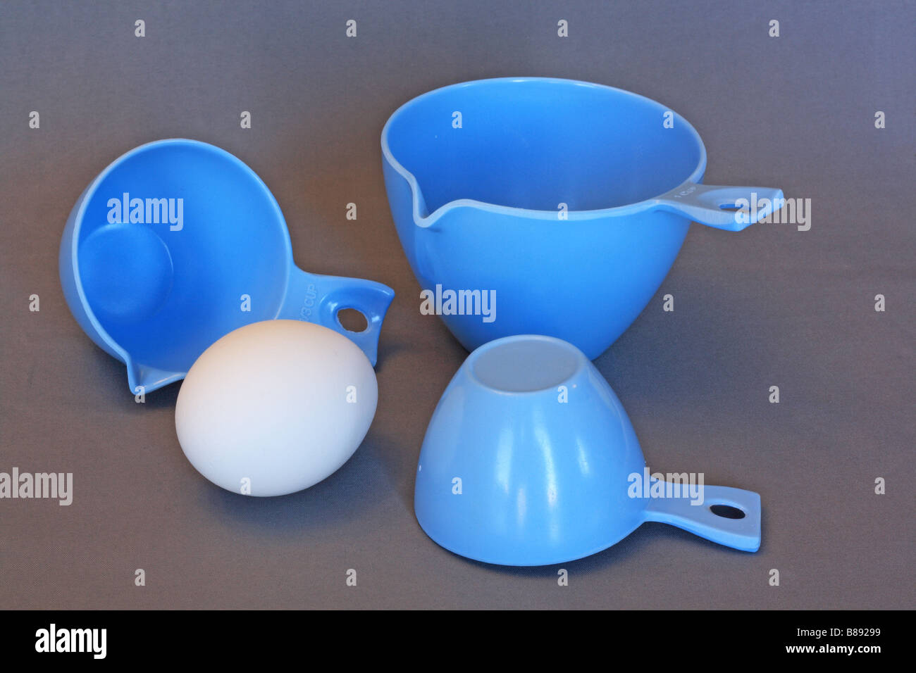 Measuring cups and egg Stock Photo - Alamy