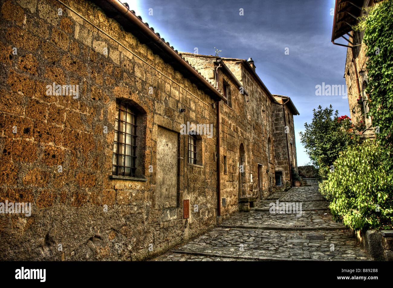 Brick stonework buildings with cobblestone alleyway in Civita di ...