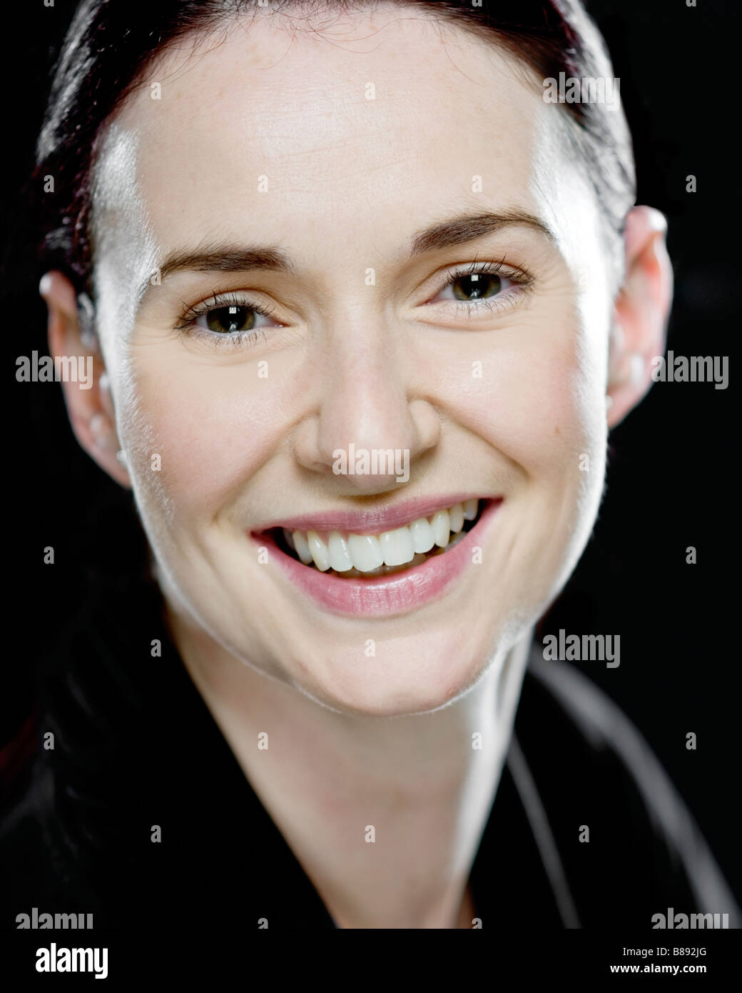 Studio portrait of young woman laughing Stock Photo - Alamy