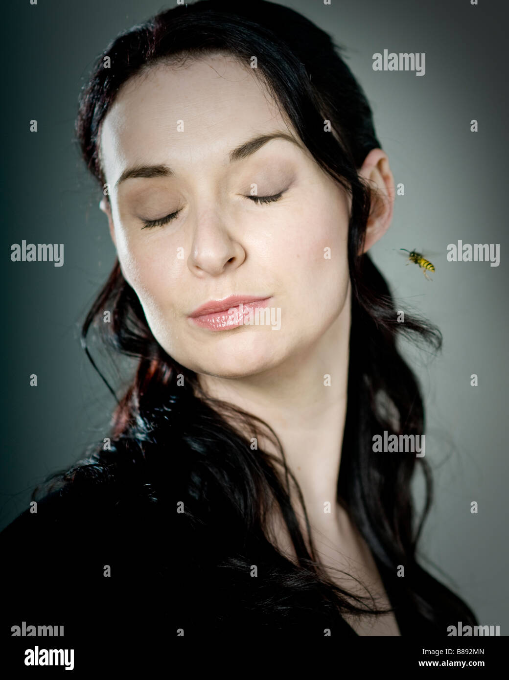 Portrait of young woman being pestered by a wasp Stock Photo - Alamy