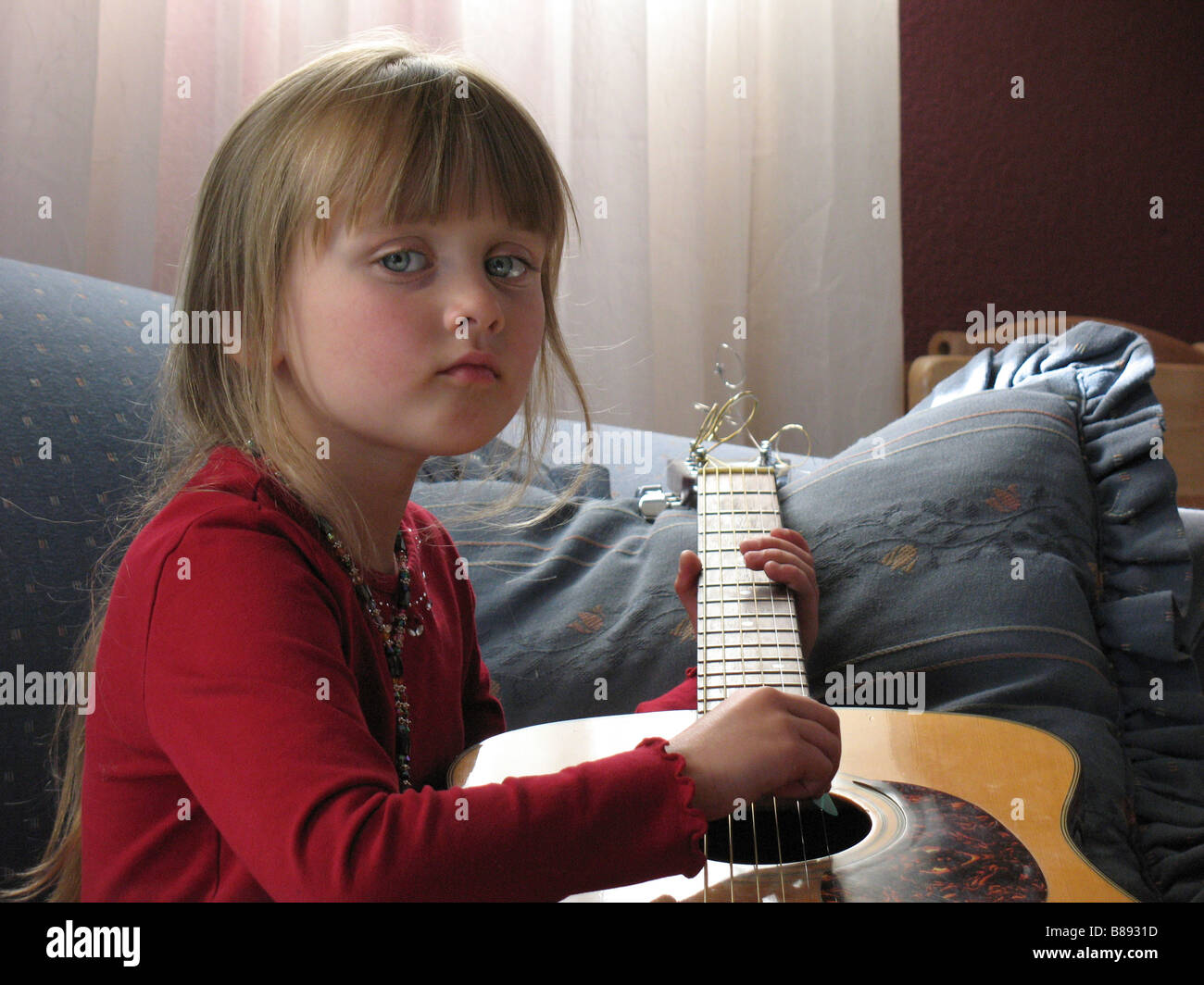 Pretty young girl with a guitar Stock Photo - Alamy