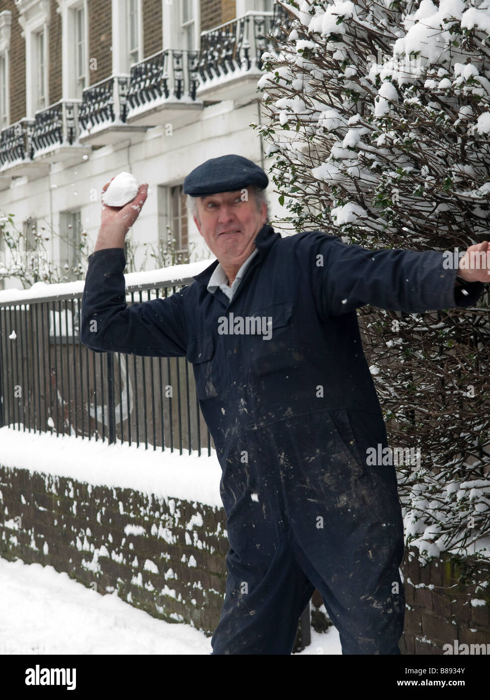 Man throwing a snowball Stock Photo - Alamy