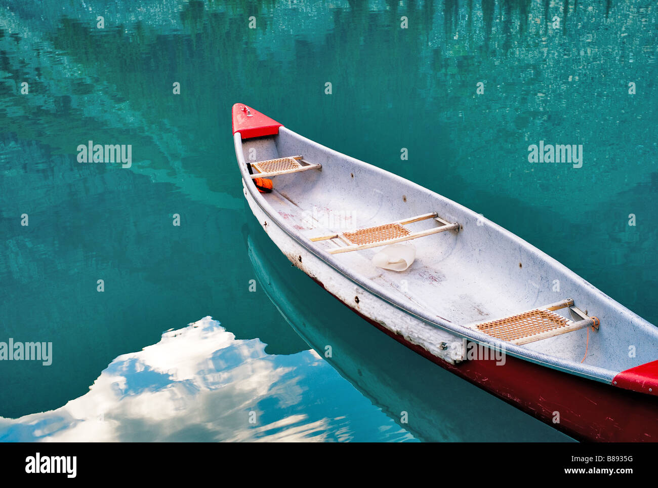 Canoe floating on reflection Stock Photo - Alamy