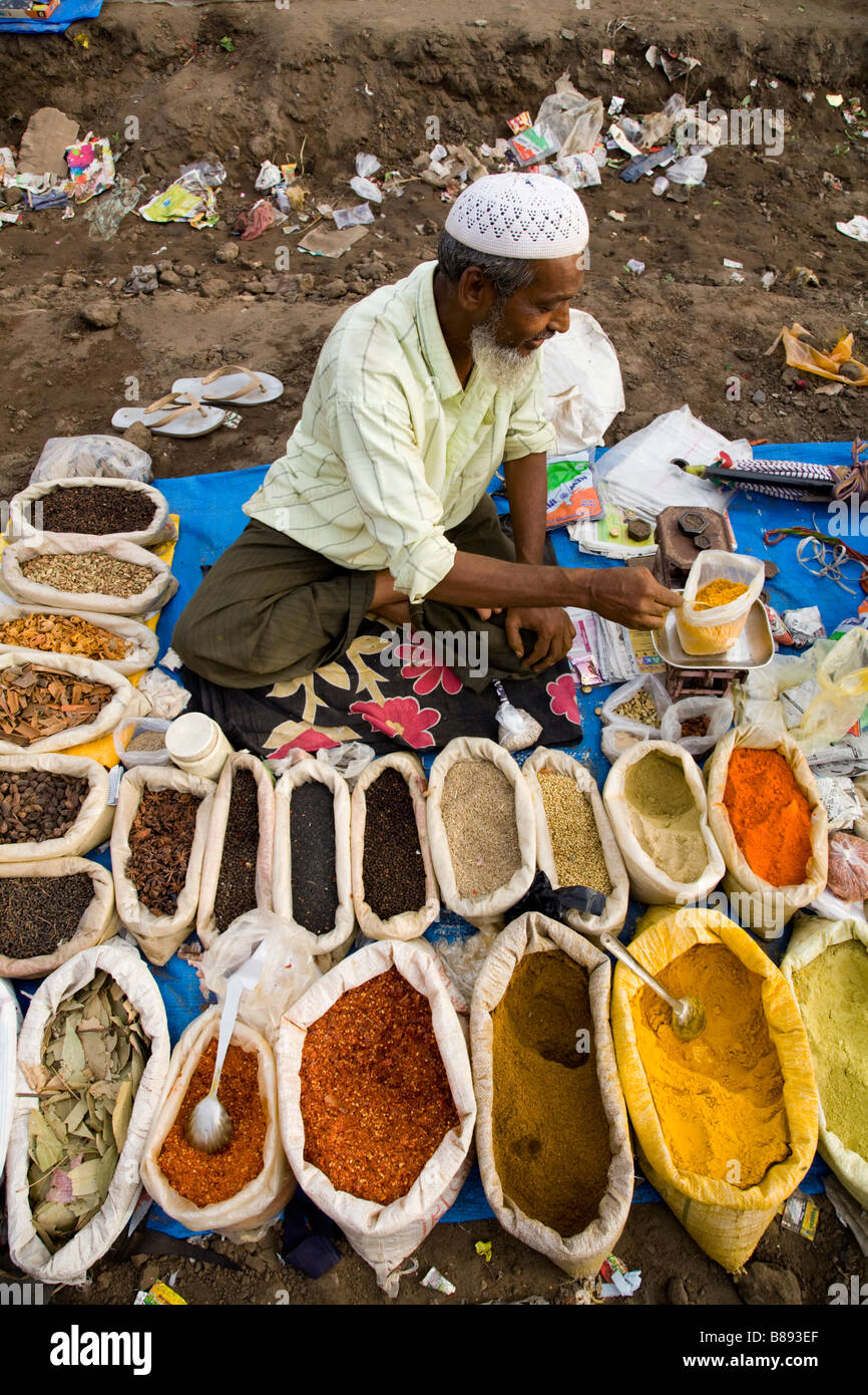 Spices for sale at a street market spice stall, with street seller ...
