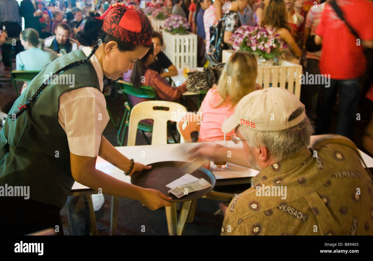 tourist paying his bill in Chinatown in Bangkok Thailand Stock Photo ...