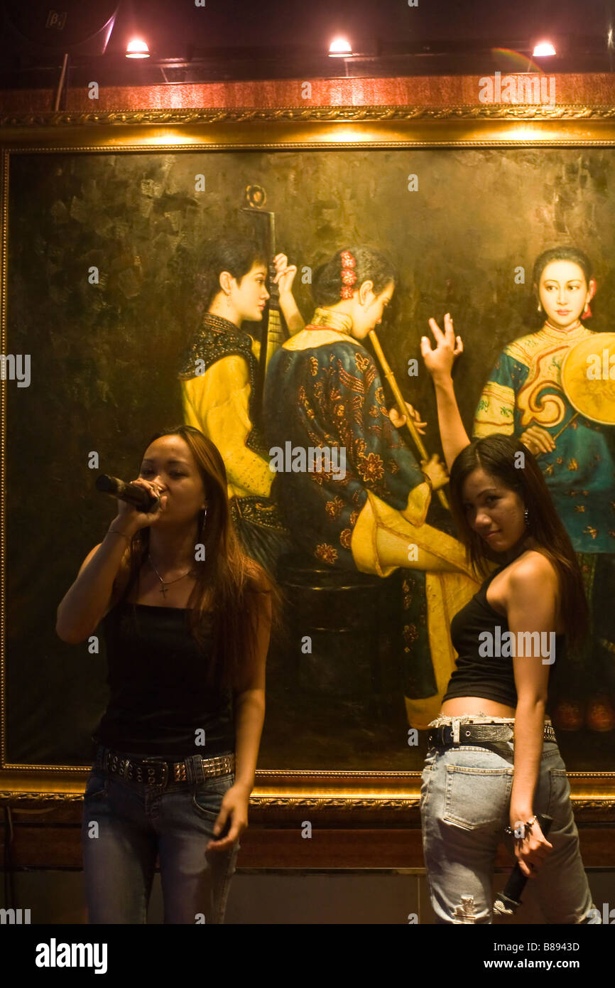 Chinese girls singing karaoke in front of a traditional chinese ...