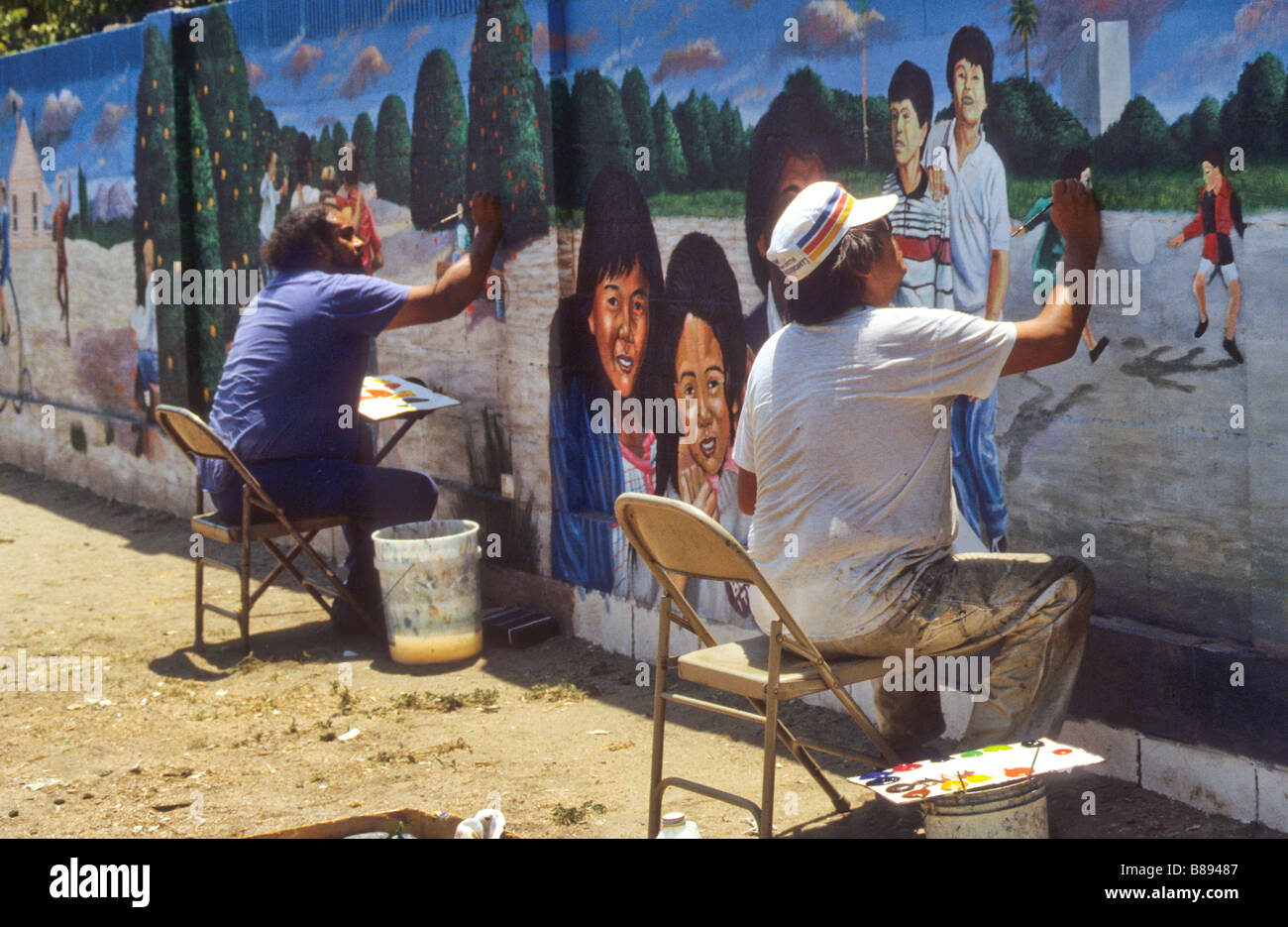 Two men paint murals in Los Angeles Stock Photo - Alamy
