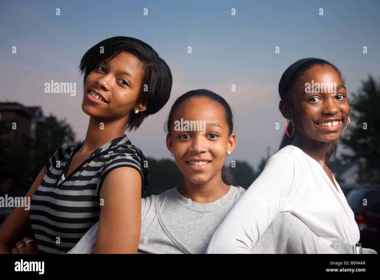 Three beautiful smiling teenage African American girls outdoors Stock ...