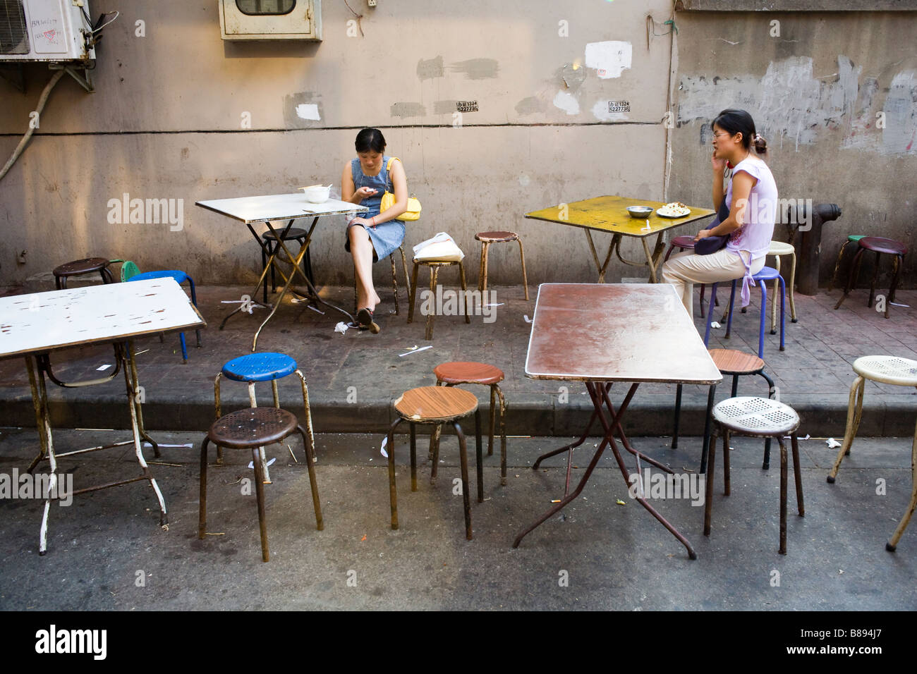 Empty tables in a street restaurant in Nanjing, China Stock Photo - Alamy