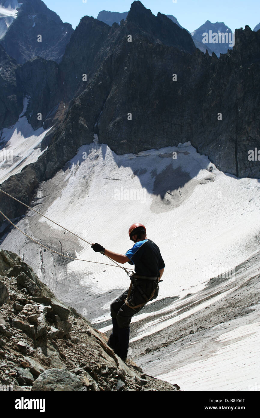 climber descending with rope in his hands Stock Photo - Alamy