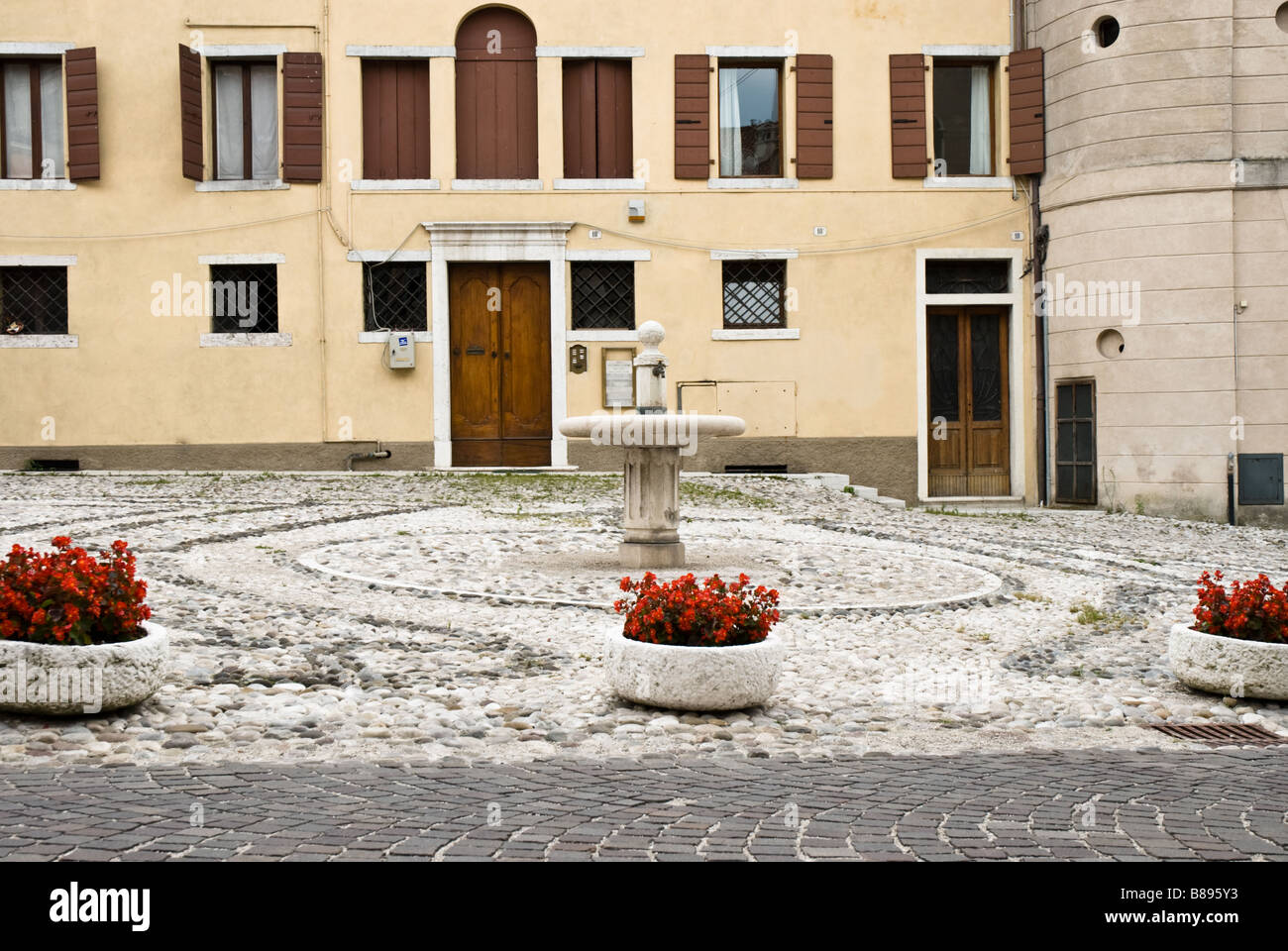 Small square with stones floor and a fountain Feltre Veneto Italy Stock ...
