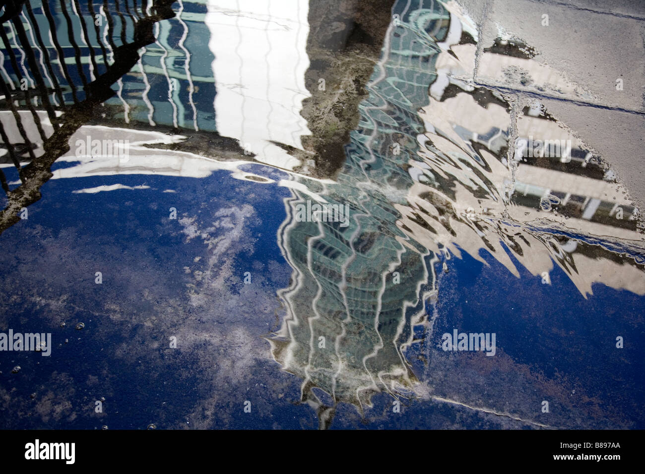 city of london skyline seen in a puddle Stock Photo - Alamy